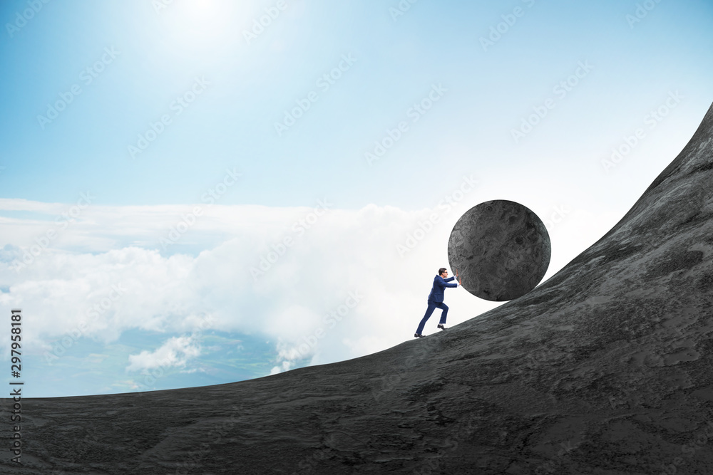 Man pushing large stone to the top Stock Photo | Adobe Stock