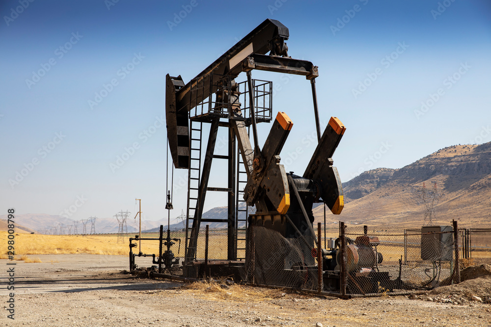 Oil drilling derricks at desert oilfield. Crude oil production from the ...