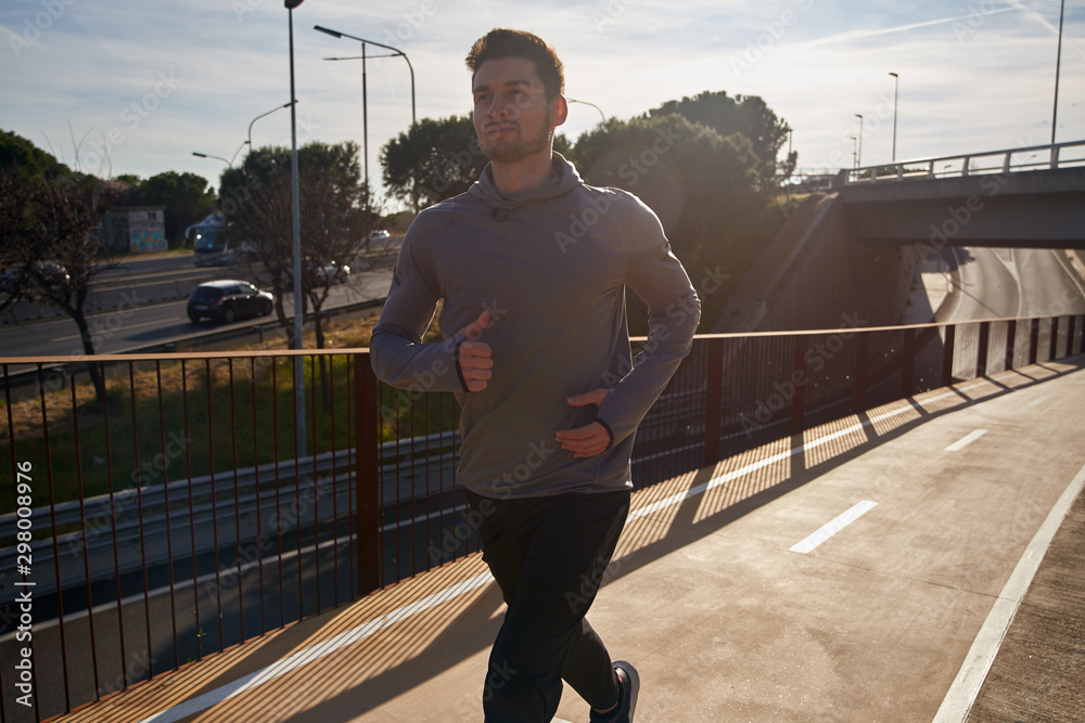 Man holding his arms akimbo and running Stock Photo | Adobe Stock