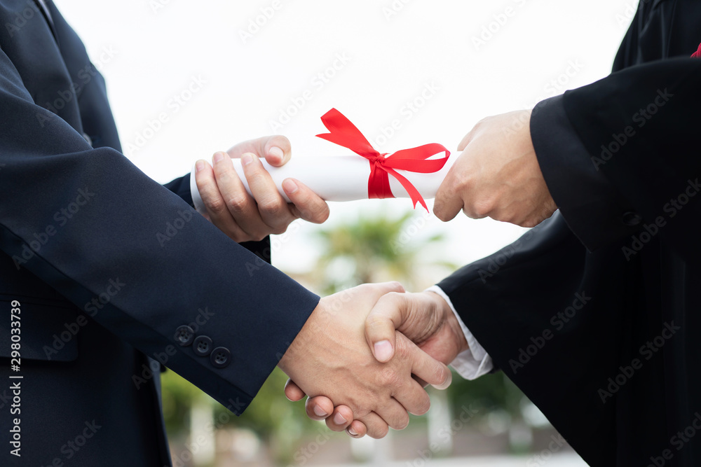 Close up Professor handshake of graduate congratulations celebrating ...