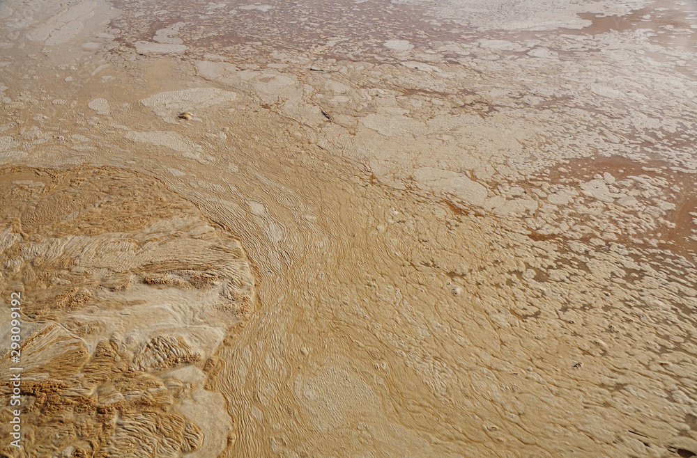 From above natural texture of spotted muddy water in swamp with stains ...