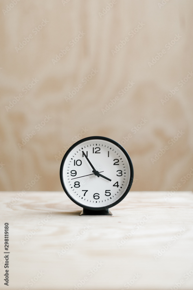 analog alarm clock on wood table with plywood backdrop Stock Photo ...