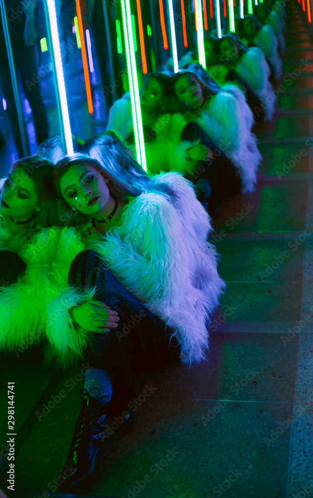 girls in mirror reflection with neon light Stock Photo | Adobe Stock