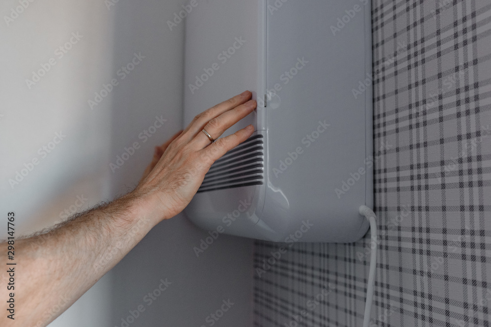 Crop man using new air conditioner Stock Photo | Adobe Stock