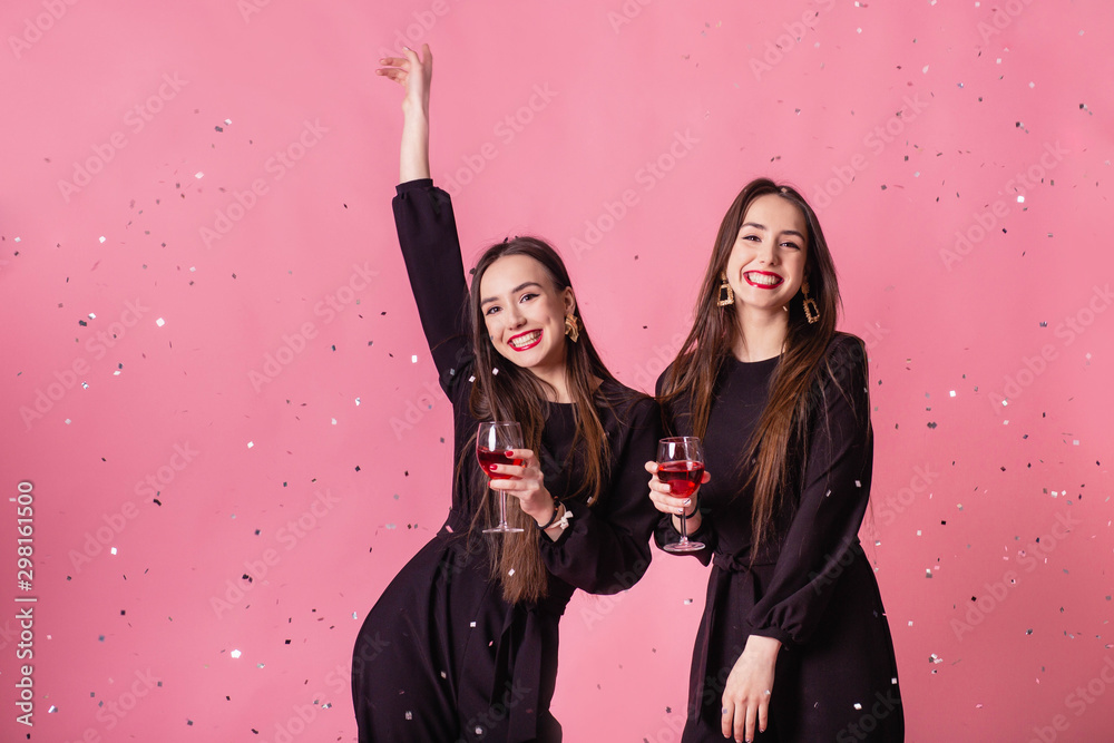 Two women celebrate the New Year party having fun laughing under the ...
