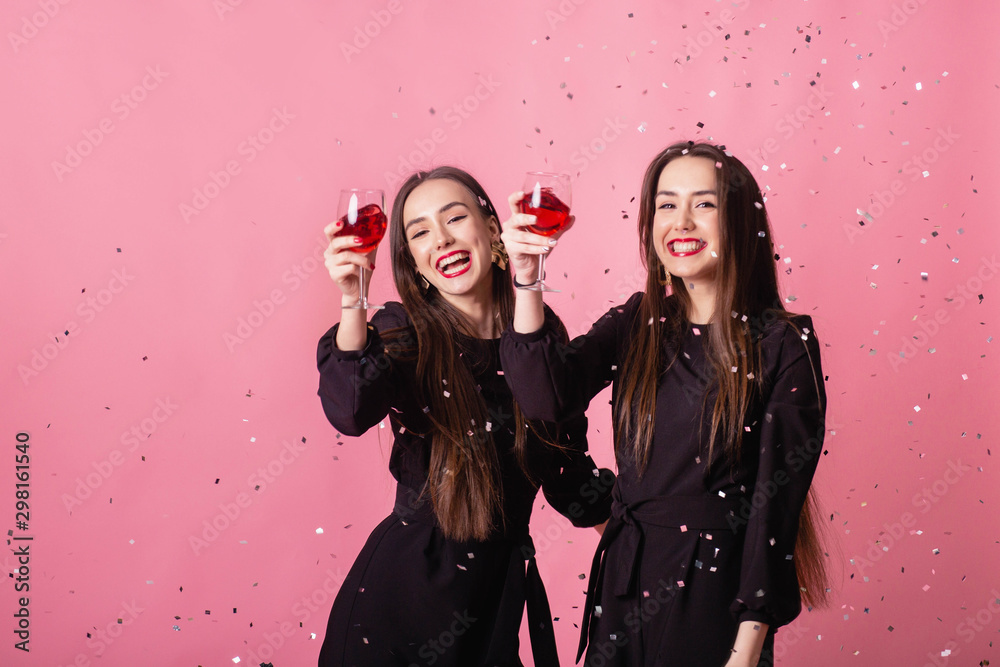 Two women celebrate the New Year party having fun laughing under the ...