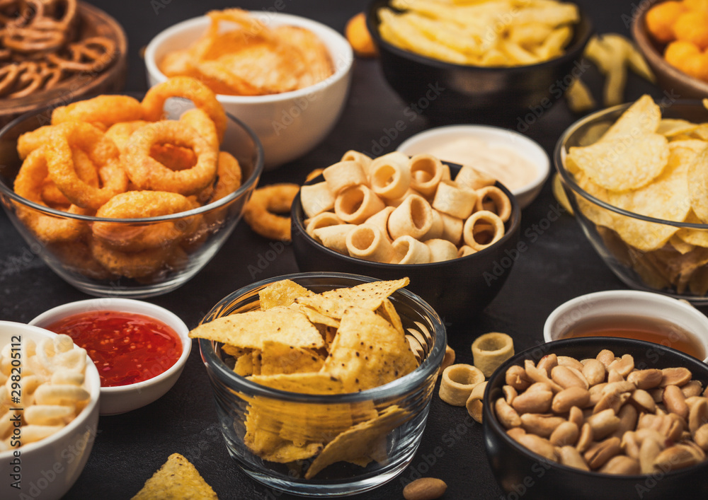 All classic potato snacks with peanuts, popcorn and onion rings and ...
