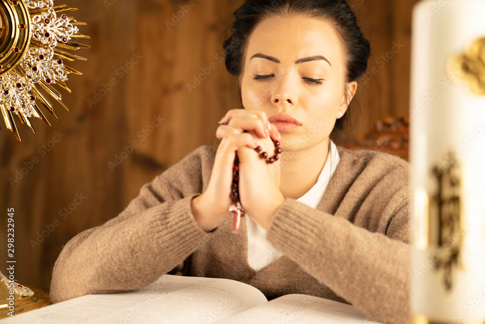 Christian woman with Bible praying in church by the altar. Woman ...
