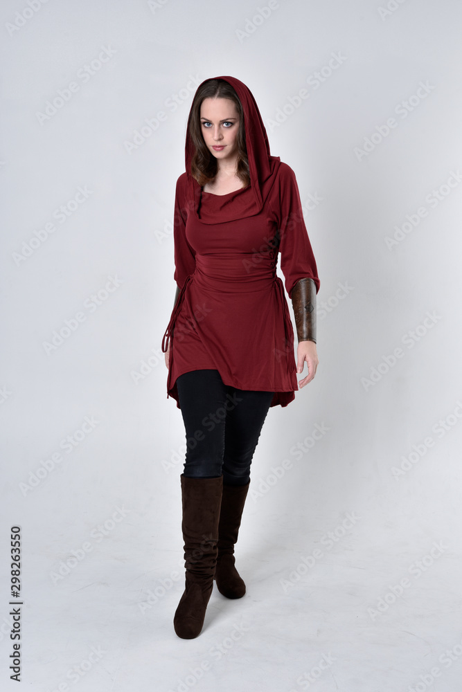 full length portrait of a brunette girl wearing a red fantasy tunic ...