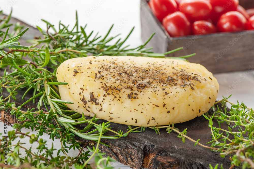 A piece of grilled halloumi cheese with fried tomatoes, thyme and Basil ...