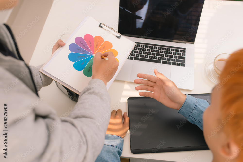 Teamwork of creative designers working choose color swatch samples for ...