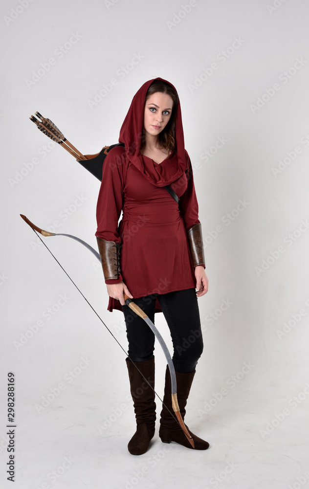 full length portrait of a brunette girl wearing a red fantasy tunic ...