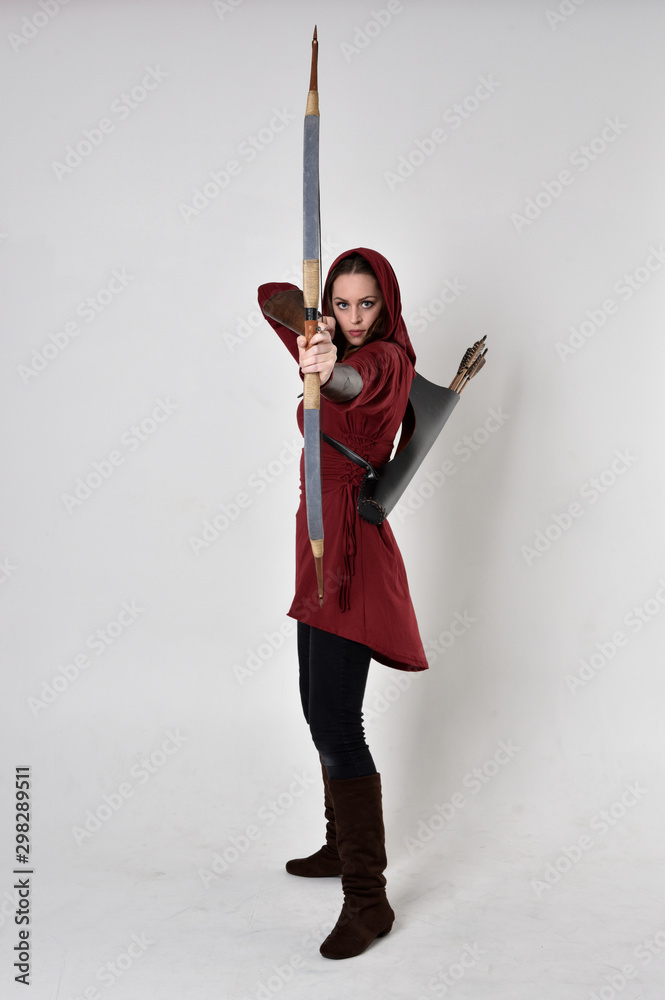 full length portrait of a brunette girl wearing a red fantasy tunic ...