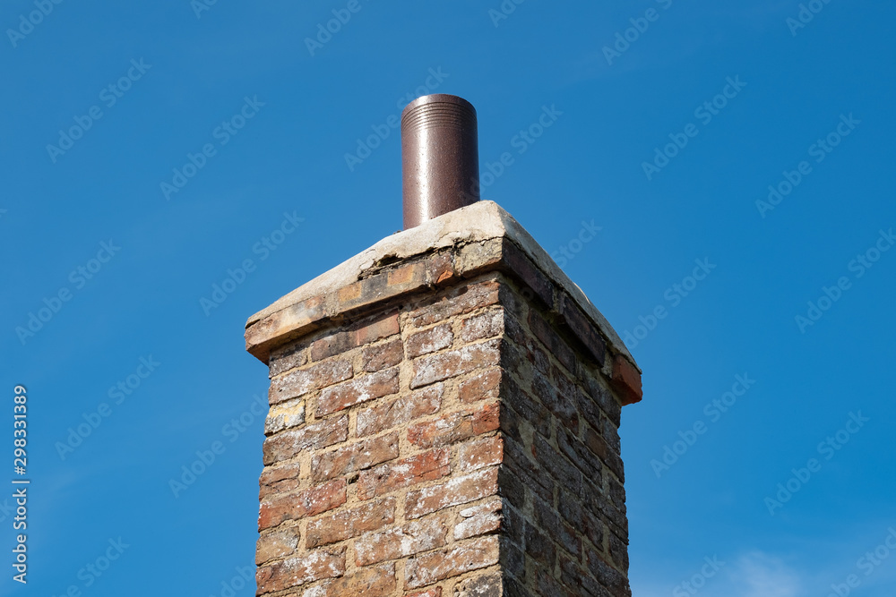 Detailed view of a very old chimney, located on a famous house. Cracks ...