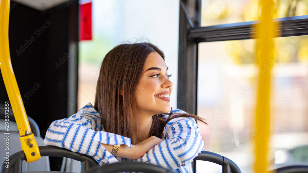 Woman traveler contemplating outdoor view from window of bus. Young ...