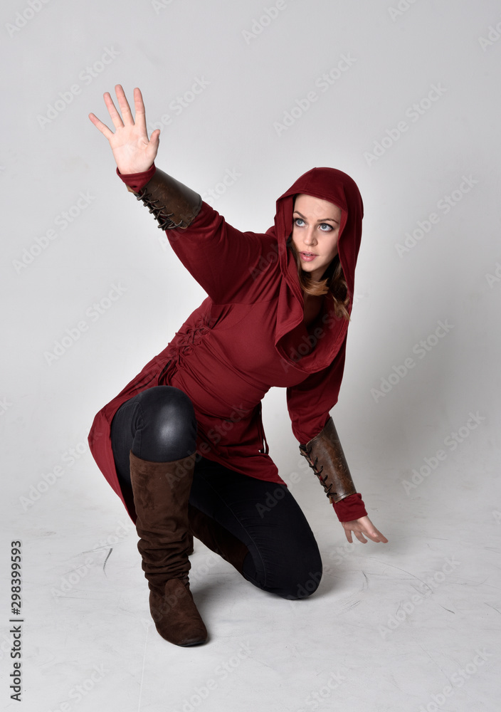 full length portrait of a brunette girl wearing a red fantasy tunic ...