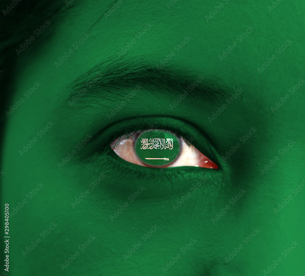 Human face painted Saudi Arabia flag with the Shahada or Muslim creed ...
