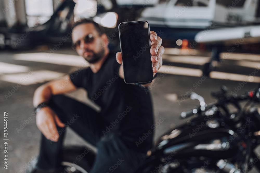 Caucasian man showing screen of his cell phone to camera Stock Photo ...