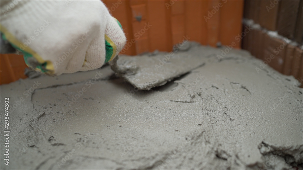Ceramic blocks. Worker puts a red ceramic block. Building a house from ...