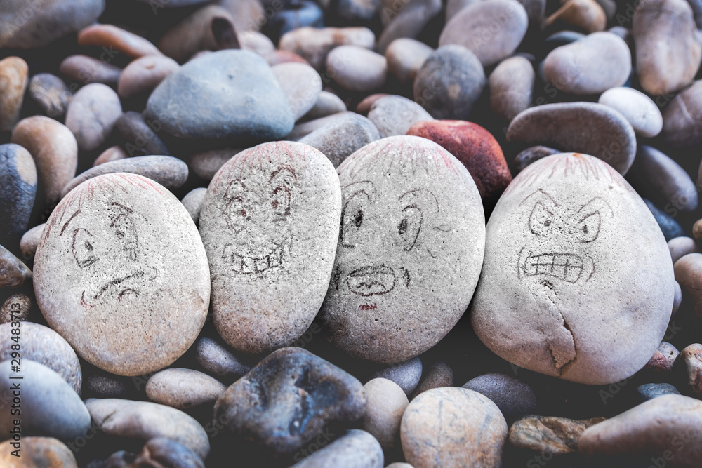 managing emotions emoji faces on stones - sad, happy, surprised worried ...