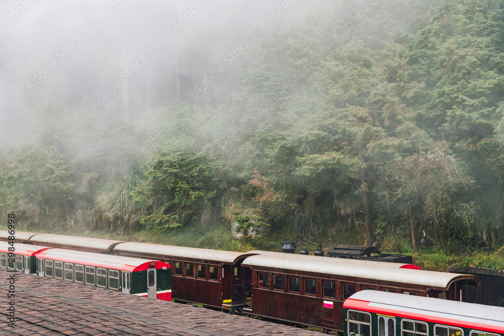 Red trains in Alishan Forest Railway stop on the platform of Zhaoping ...