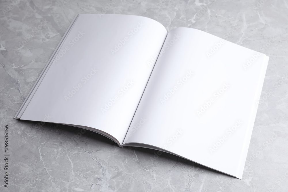 Blank open book on light grey marble background. Mock up for design ...