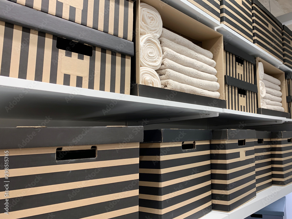 Rows of stacked storage carton boxes and home textyle stacked on ...