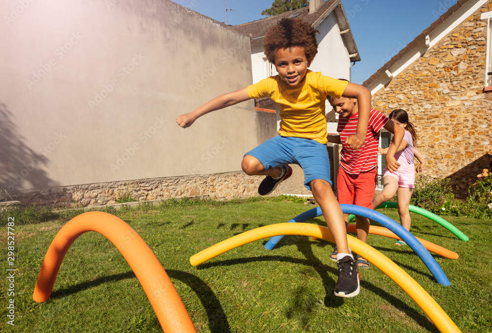 Race game with obstacles boys jump over barrier Stock Photo | Adobe Stock
