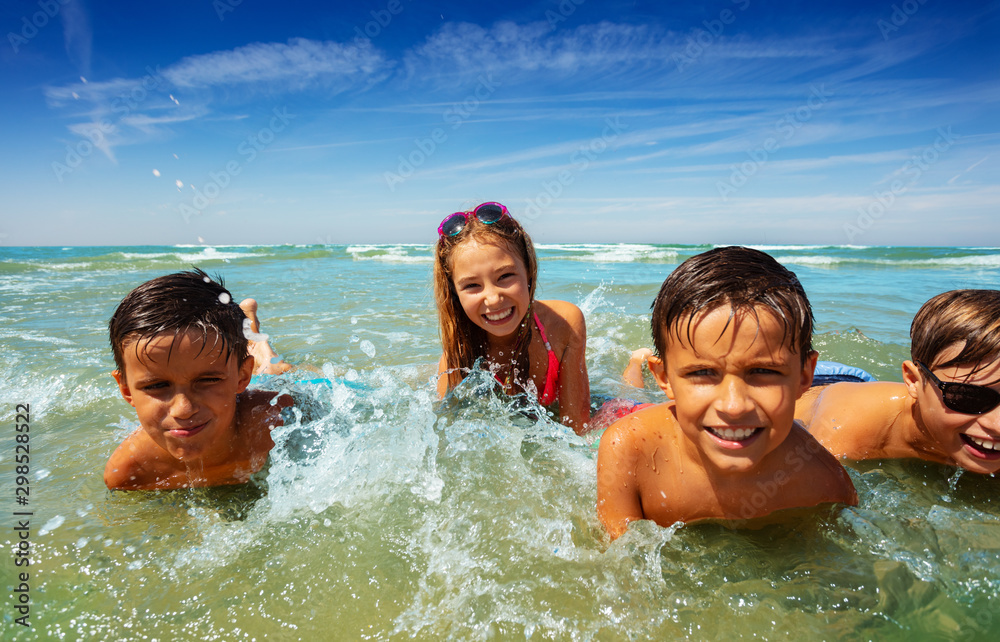 Group of kind swim and play in the ocean waves Stock Photo | Adobe Stock