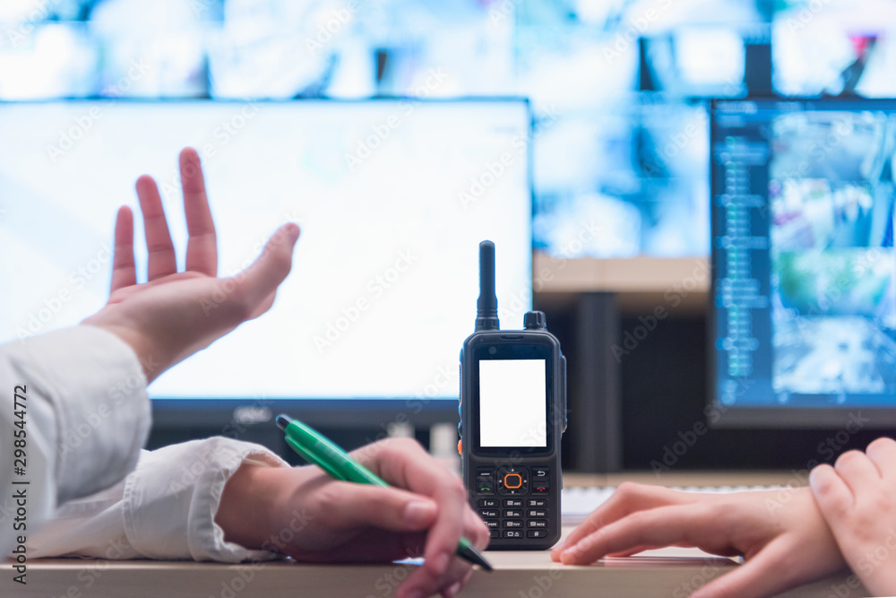 Security guard monitoring modern CCTV cameras in surveillance room. Two ...