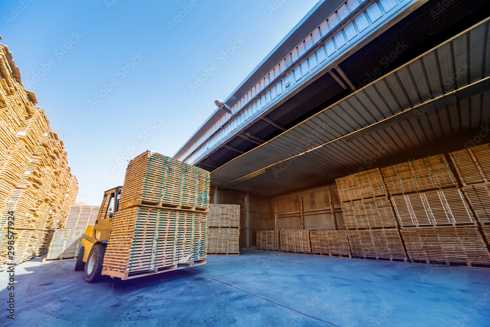 Forklift loader load lumber into a dry kiln. Wood drying in containers ...