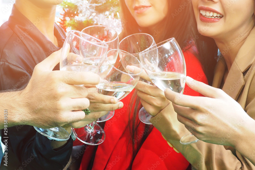 Group of people celebrating party with clear glasses of wine and ...