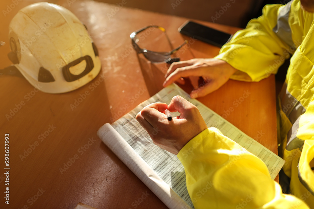 Top view of young construction gold miner worker hand holding pen ...
