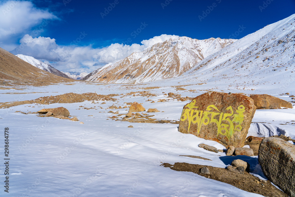 Sanskrit text of carved Buddhist mani stone or prayer stone say Om Mani ...