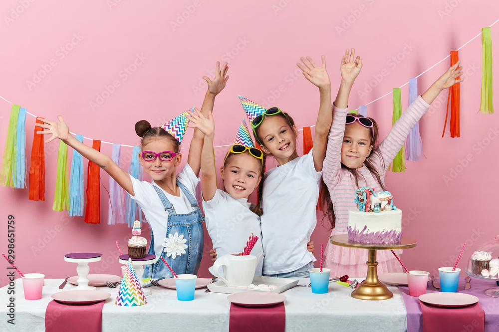 female party. little cute girls enjoying birthday, isolated pink ...