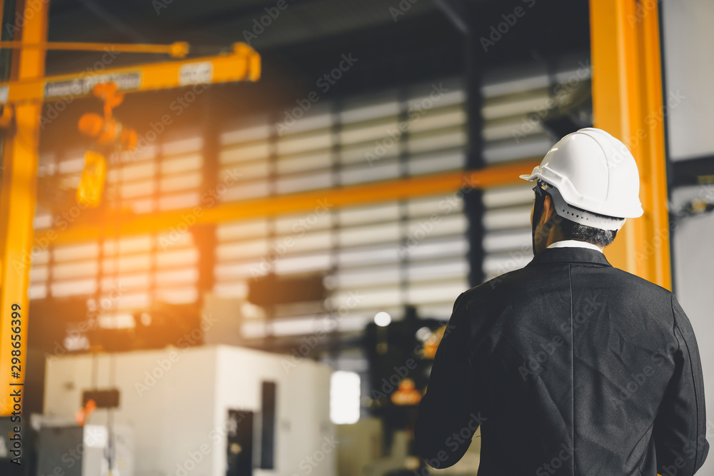 industrial Engineer or Manufacturer wearing white hard safety helmet ...