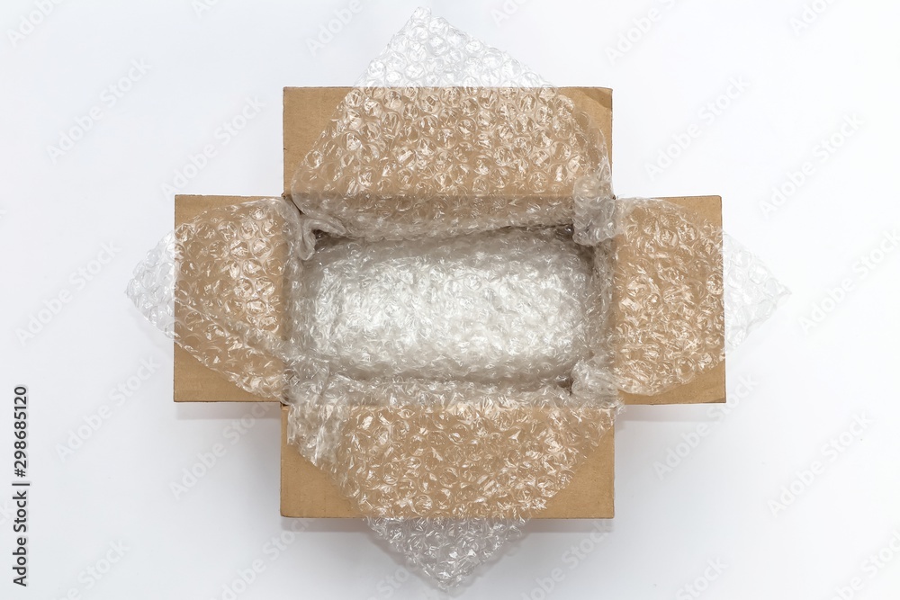 Plastic air bubble wrapped items in a brown parcel cardboard box, ready ...