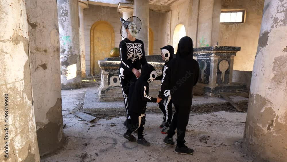 Children and their mother in carnival costumes celebrate Halloween in ...