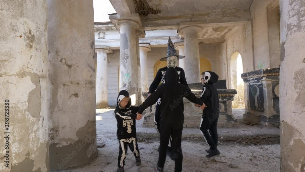 Children and their mother in carnival costumes celebrate Halloween in ...