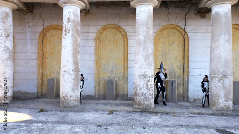 Children and their mother in carnival costumes celebrate Halloween in ...