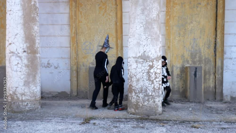 Children and their mother in carnival costumes celebrate Halloween in ...