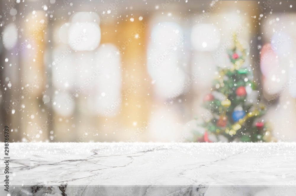 Empty white mable stone table top on blur with bokeh Christmas tree and ...