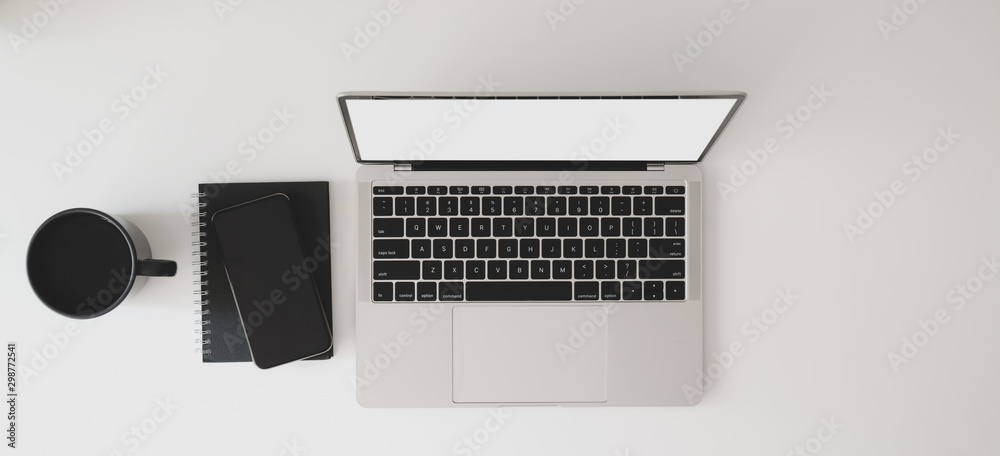 Top view of modern workspace with laptop computer, notebook and coffee ...