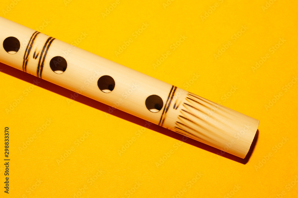 Bamboo flute. simple wind instrument on yellow background Stock Photo ...