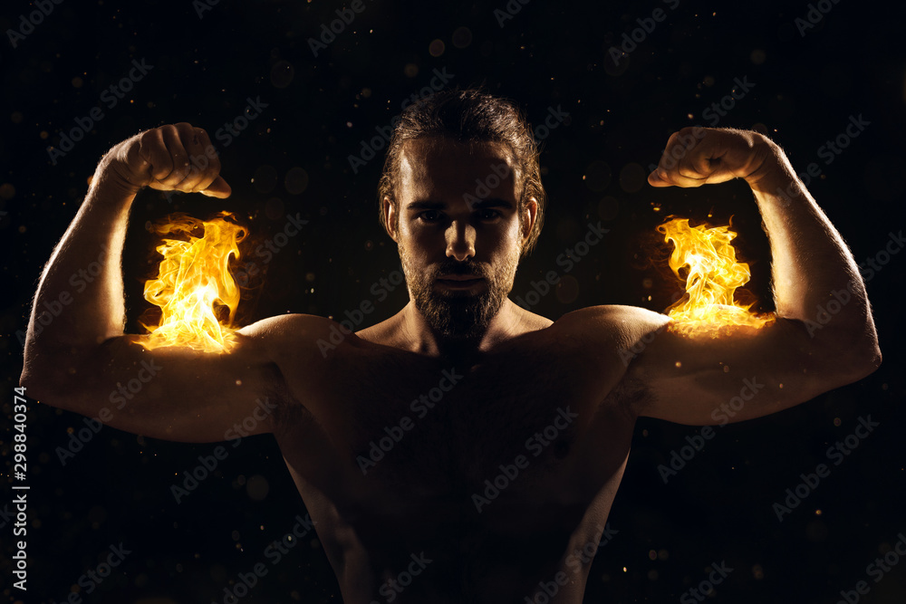 Shirtless man posing with biceps on fire Stock Photo | Adobe Stock