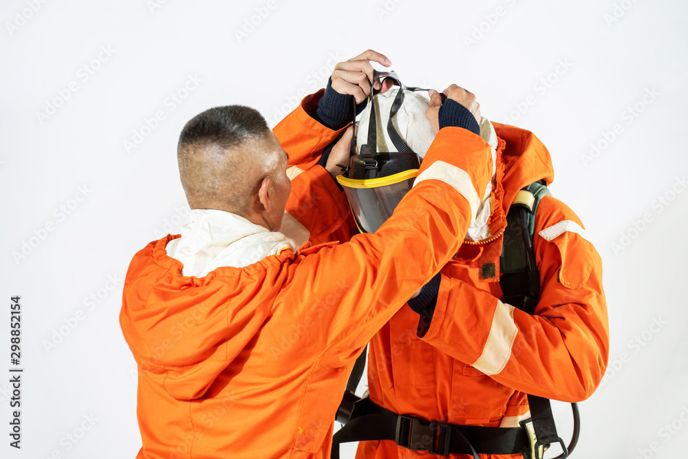 Firefighter or fireman in fire suit helping friend wearing fire ...