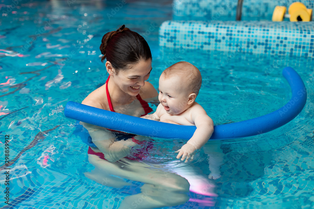 baby with mom learns to swim in the pool Stock Photo | Adobe Stock