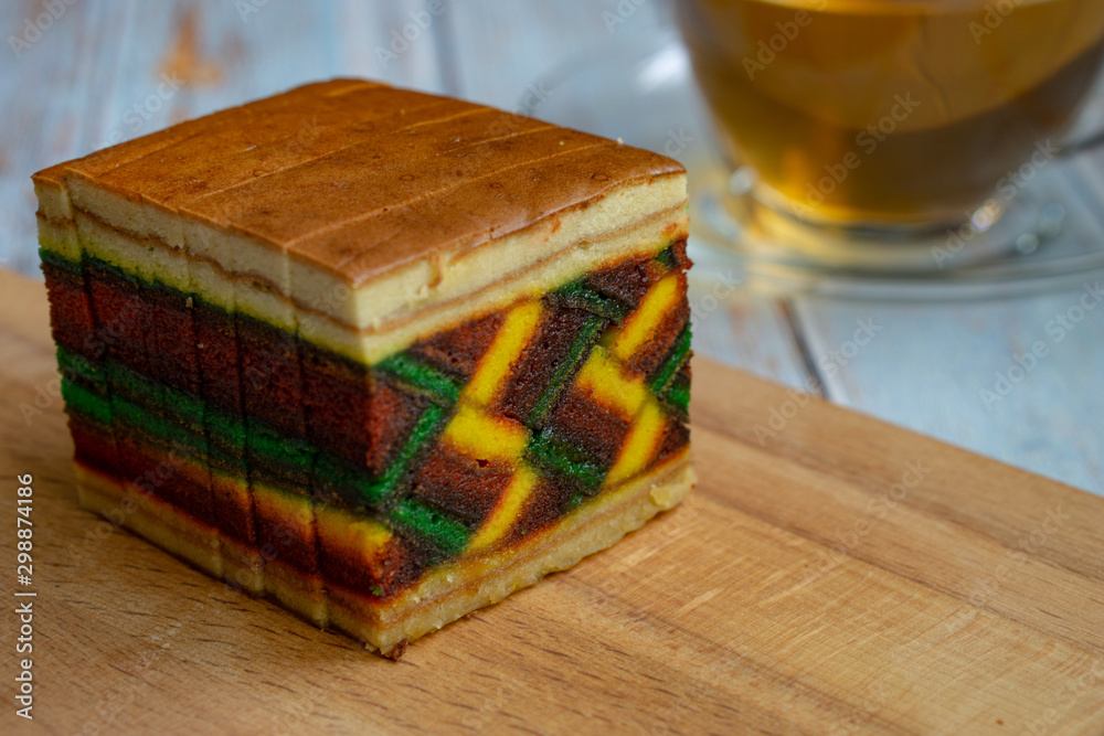 Malaysian dish "Kek Lapis Sarawak" or Sarawak layered cake over wooden ...