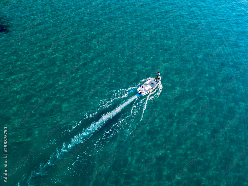 Aerial view of a rowing boat seen from above, powered by an engine ...