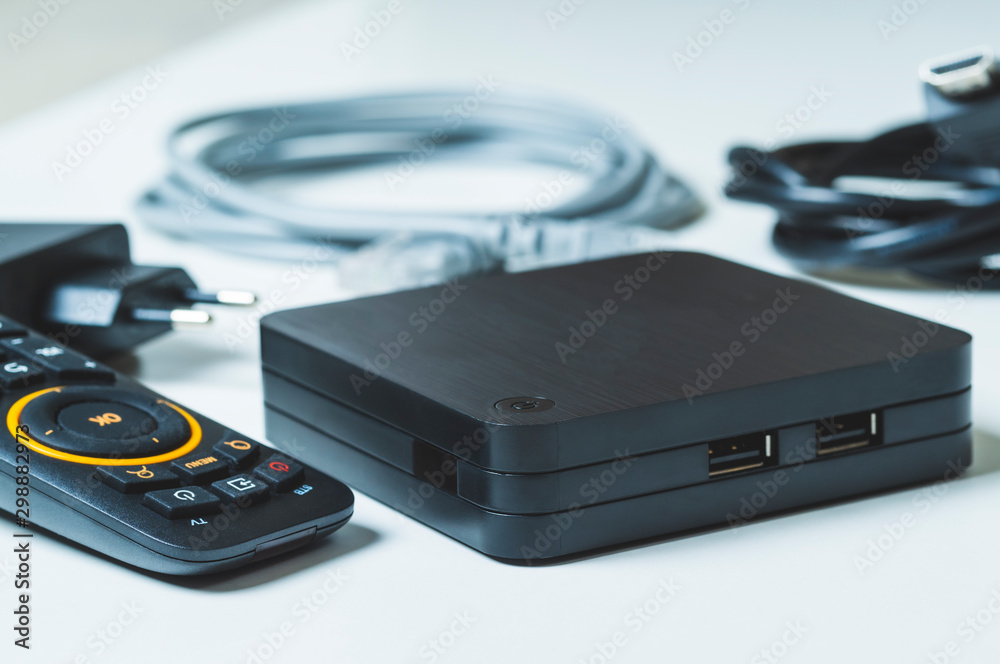 TV set-top box and all the necessary wires to connect it on a white ...